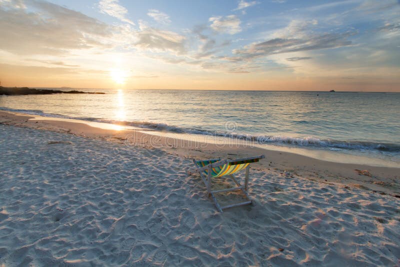 Sunset at beach with chair stock photo. Image of sunrise - 103419050
