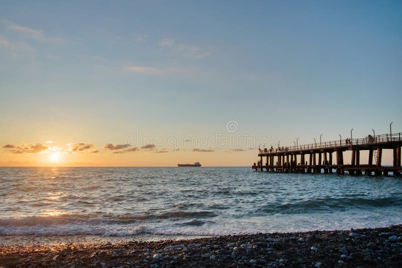 A Sunset on the Beach with Crowded Pier Stock Photo - Image of dusk ...