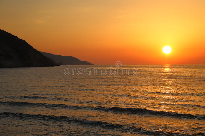 Sunset on the Beach with Distant Mountains Stock Image - Image of ...
