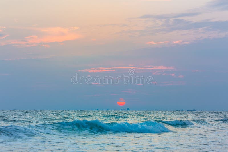 Sunset at the Beach and with Fishing Boats and Cargo Ships. Stock Image ...