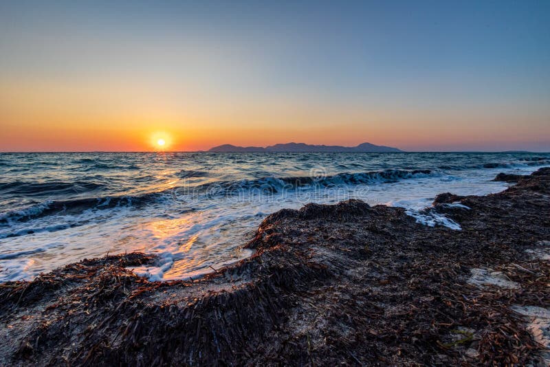 Sunset at the beach in kos stock image. Image of colorful - 267134283