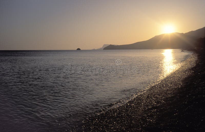 Sunset on beach, Crete stock image. Image of tourism - 131066111