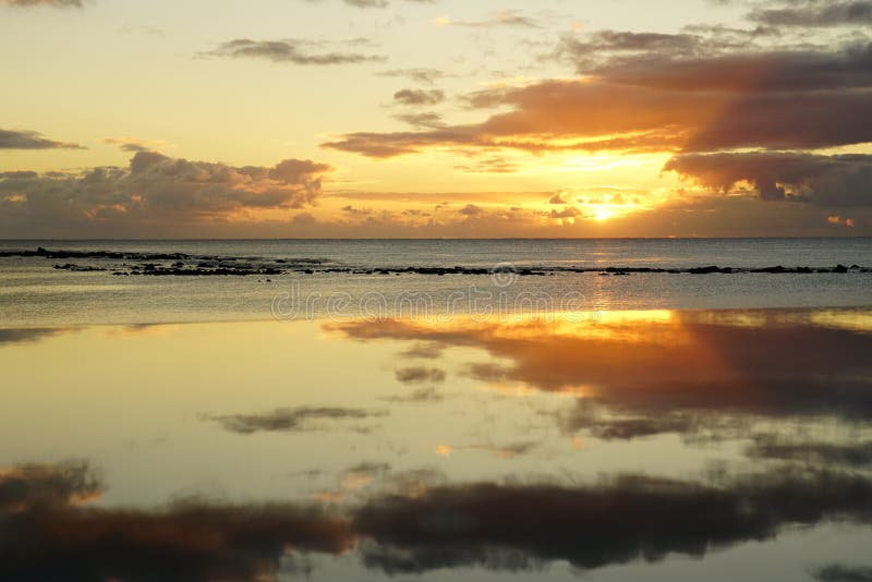 Sunset in an Infinity Pool by a Tropical Beach and Reflection on the ...