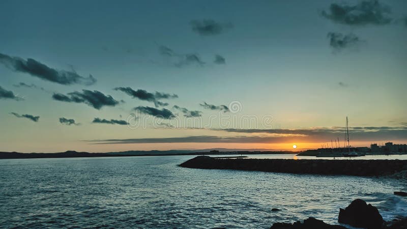 Sunset from the Beach with Rocky Dock and Ships Stock Image - Image of ...