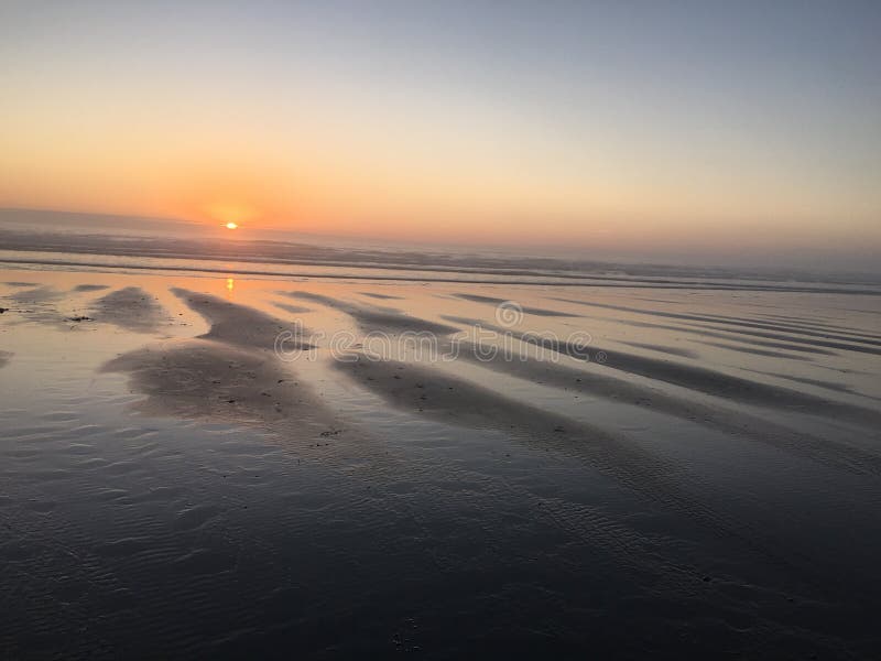 Sunset stock photo. Image of water, oregon, beach, sand - 76917952