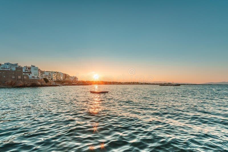 Sunset on the Beach with Sun Rays Reflected in the Water Stock Photo ...