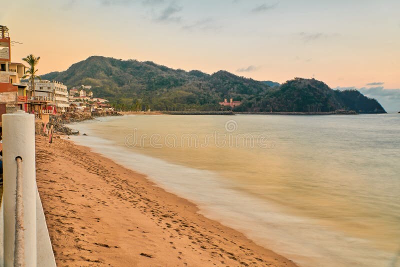 Sunset on the Beach and the Sun is Setting on the Horizon Stock Image ...