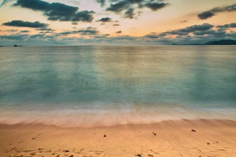Sunset on the Beach and the Sun is Setting on the Horizon Stock Image ...