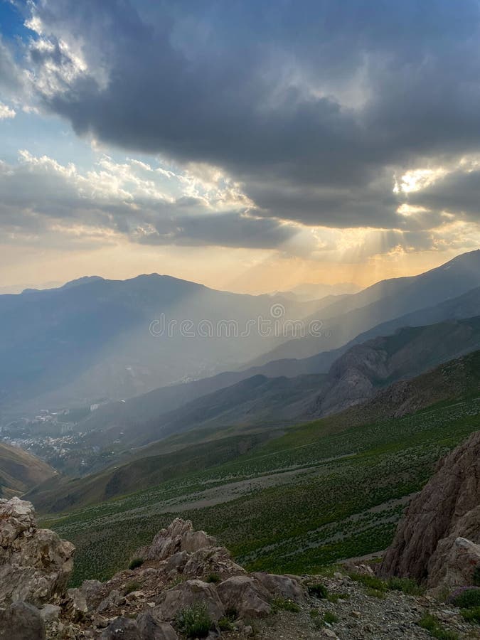 Sunset Beam Against the Background of Multi-level Mountains and ...