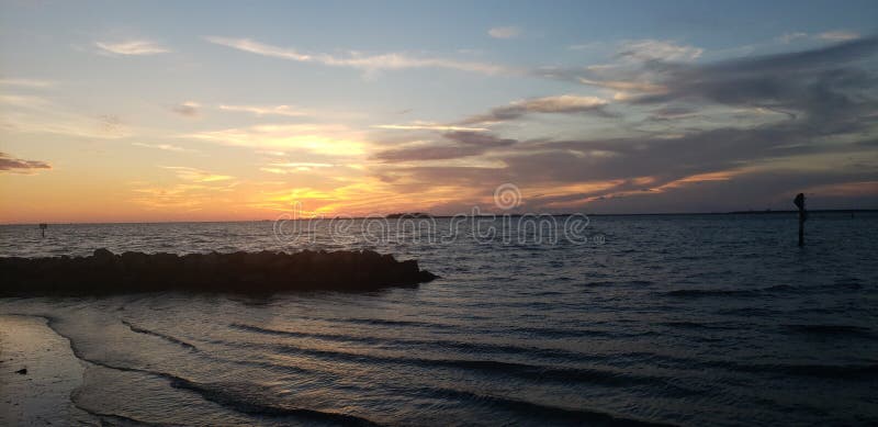 Sunset behind the clouds stock photo. Image of water - 158789178