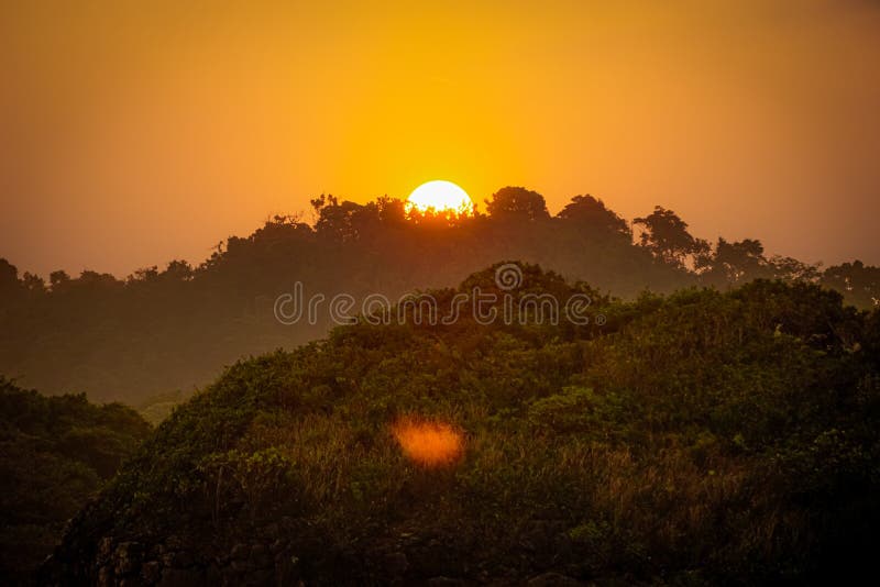 Sunset behind the hills stock photo. Image of afterglow - 221049268