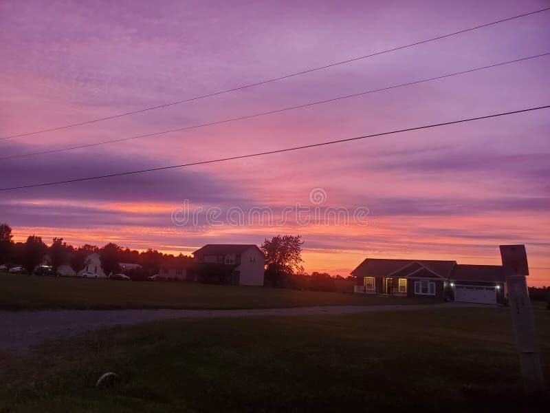 Sunset behind houses stock photo. Image of dusk, cloud - 227368848