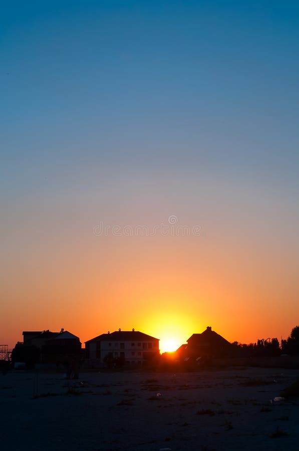 Sunset Behind the Houses and Clouds Stock Photo - Image of line, field ...