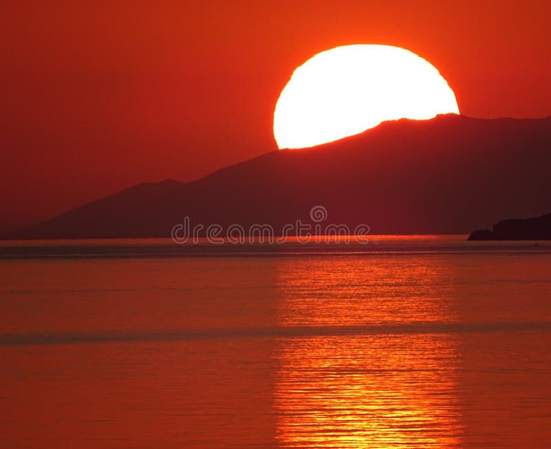 Sunset Behind a Mountain in the Beach Stock Photo - Image of yellow ...
