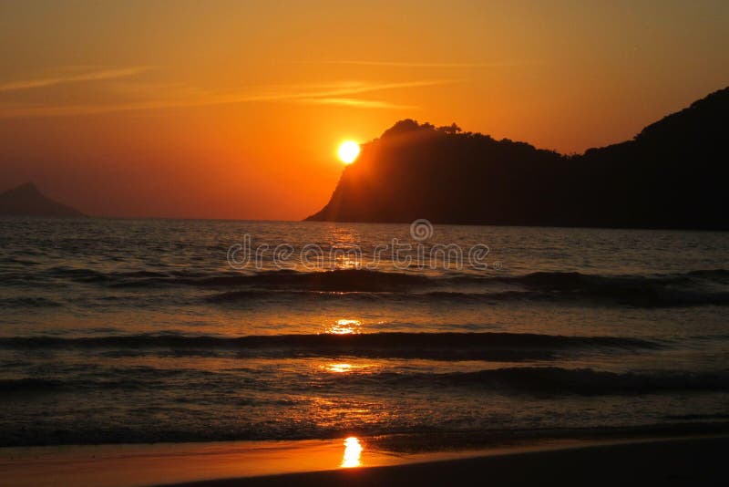 Sunset Behind the Mountain on the Beach Stock Photo - Image of ...