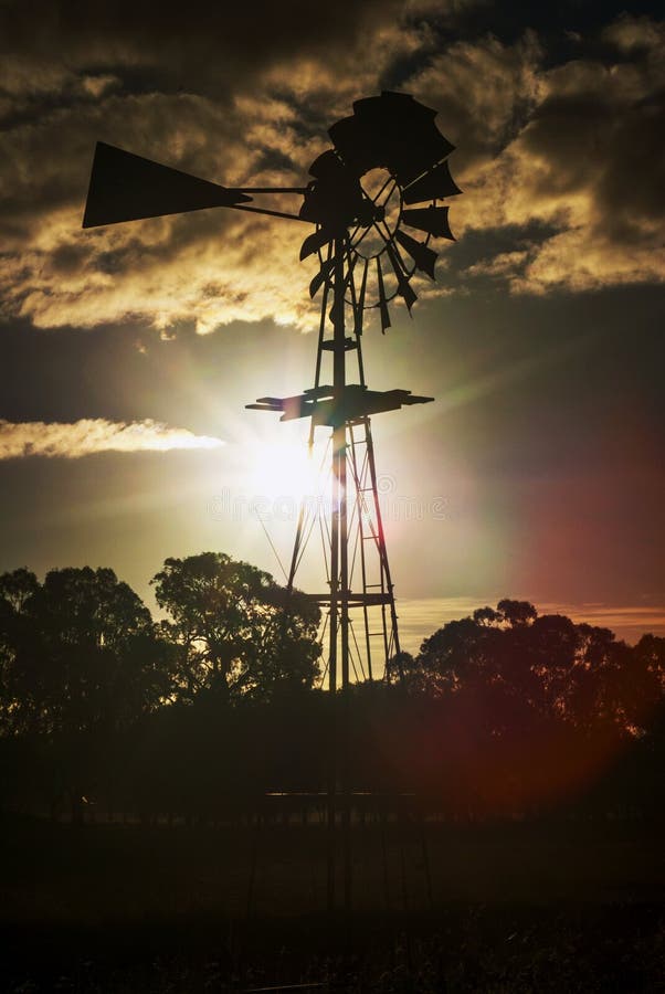 Sunset behind Windmill stock photo. Image of poster - 181393558