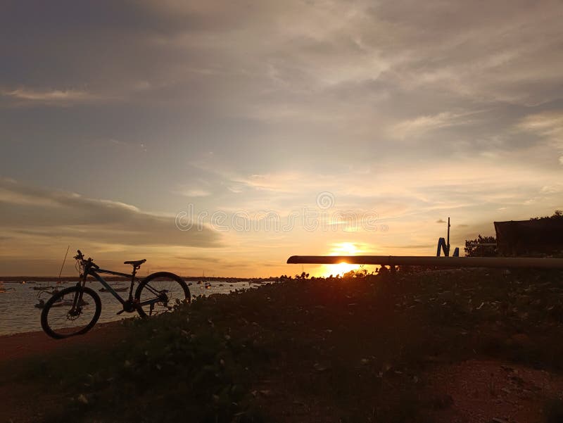 Sunset with Bicycle Silhouette at Beach Stock Photo - Image of ...