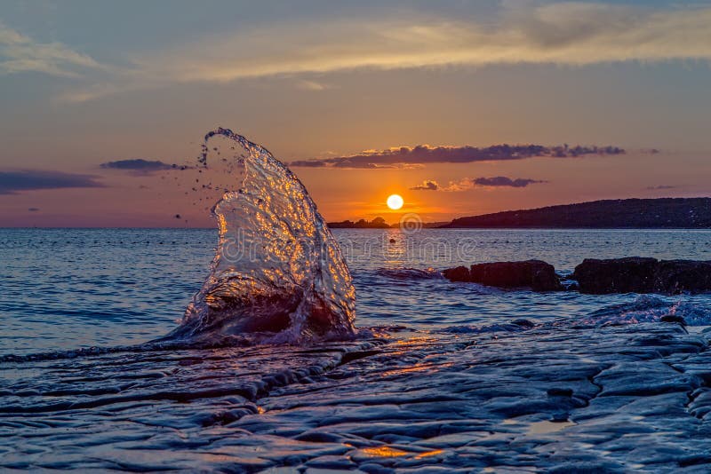 Sunset with a Big Wave in Foreground Stock Photo - Image of color ...
