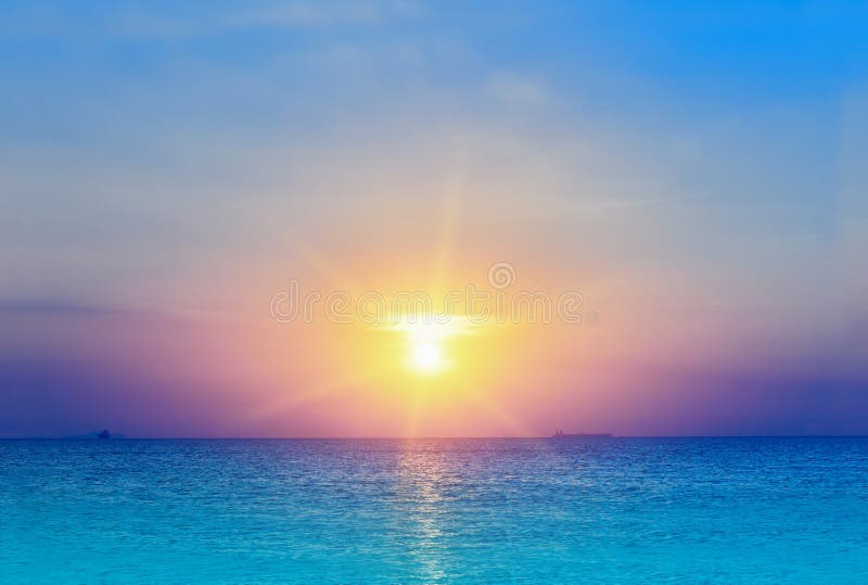 Sunset on blue seawater stock photo. Image of sunlight - 190042538