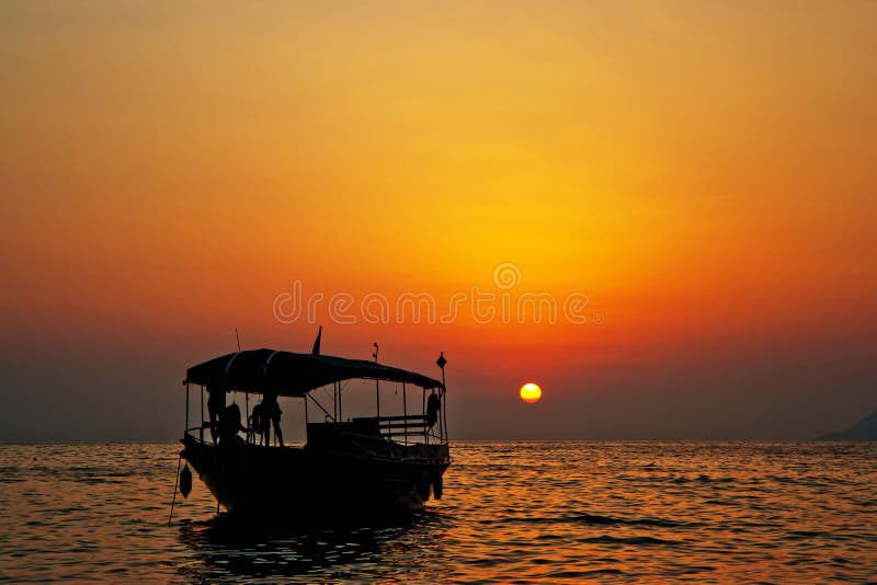 Sunset and boat stock photo. Image of calm, horizon, coast - 20795904