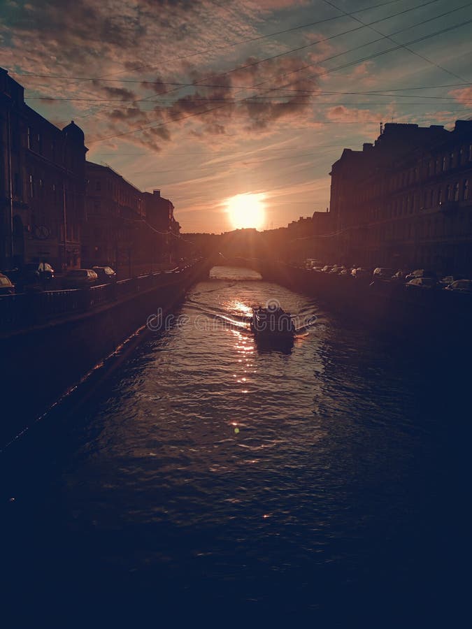 Sunset boat coming up stock image. Image of reflection - 258478143