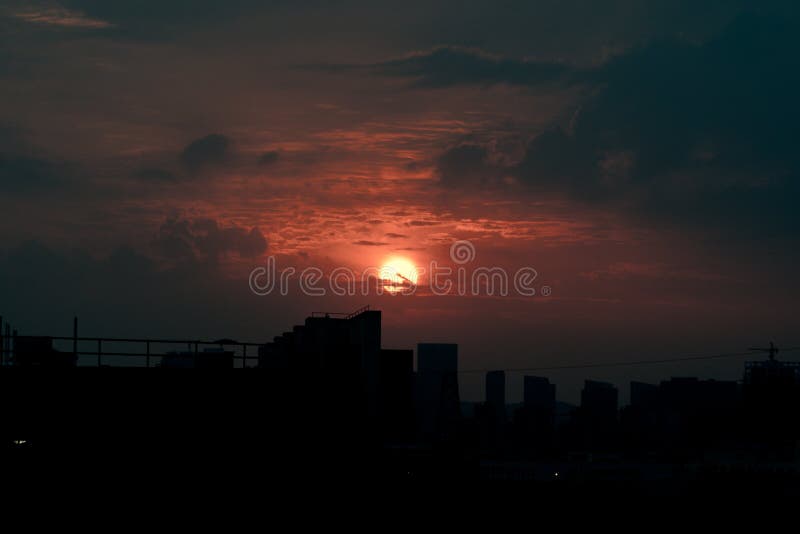 The SUNSET through Buildings Stock Image - Image of cloud, building ...