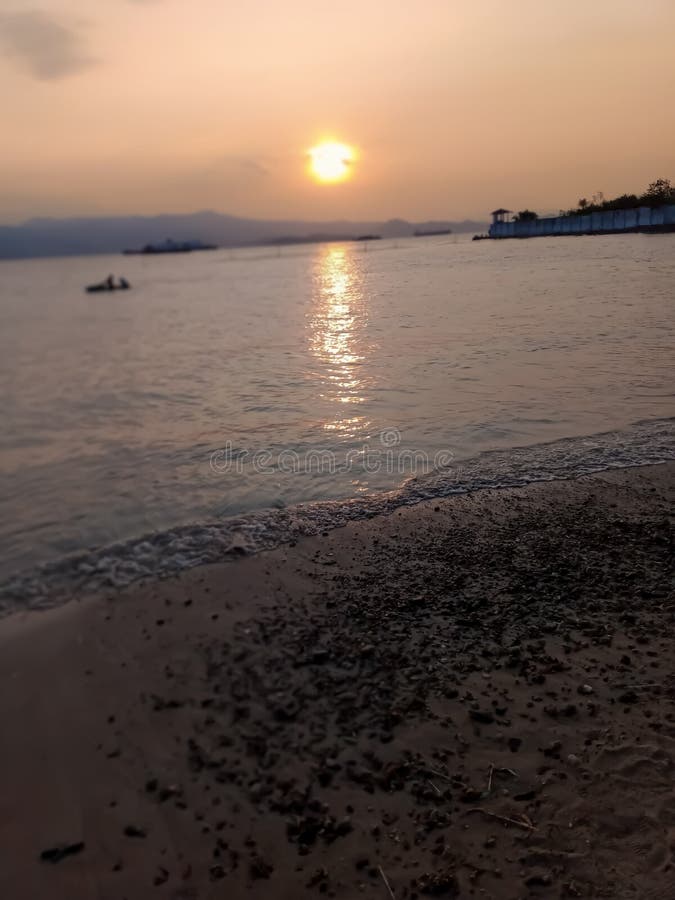 Sunset on a Calm Beach with Silhouettes of People and Boats. Stock ...