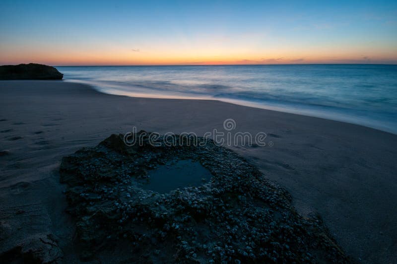 Sunset on Calm Beach Slow Shutter Seascape Stock Image - Image of rock ...