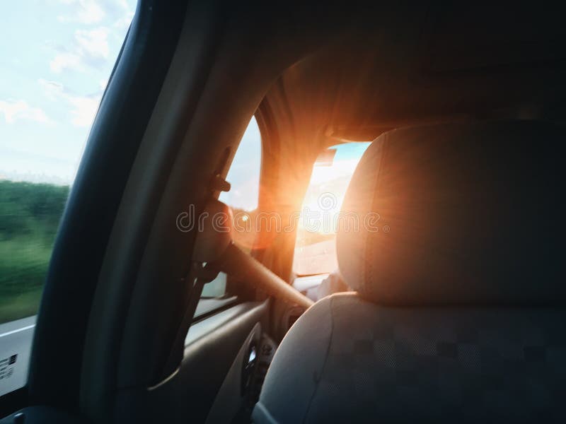 Sunset in the car stock photo. Image of looking, driving - 102525294