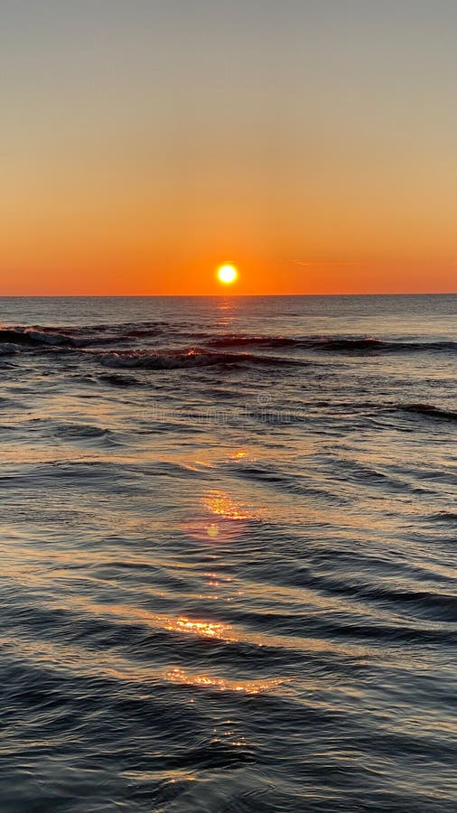Sunset with a Clear Sky Over the Ocean. Vertical Photo Stock Photo ...
