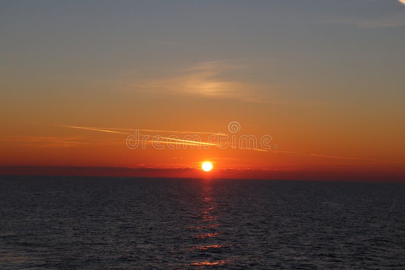 Sunset on Cloudless Sky and Calm Sea Surface in the Background Stock ...