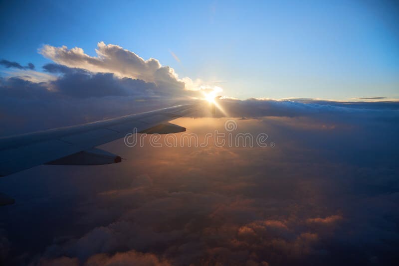 Sunset between Clouds with Airplane Wing. Stock Photo - Image of ...
