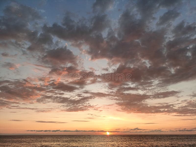 Sunset and clouds beach stock photo. Image of horizon - 243814954