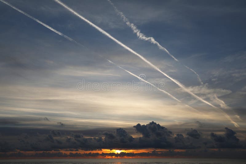 Sunset, Clouds and Contrails Over the Sea Stock Image - Image of cloudy ...