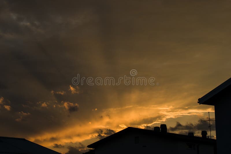 Sunset Clouds Over Roof Tops with Sun Rays Stock Photo - Image of tops ...