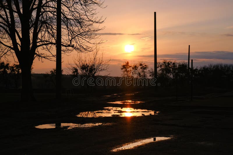 Sunset Clouds after the Rain Over Field with Puddles Stock Photo ...
