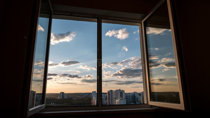 Sunset Clouds through a Window with a Reflection in the Window Casement ...