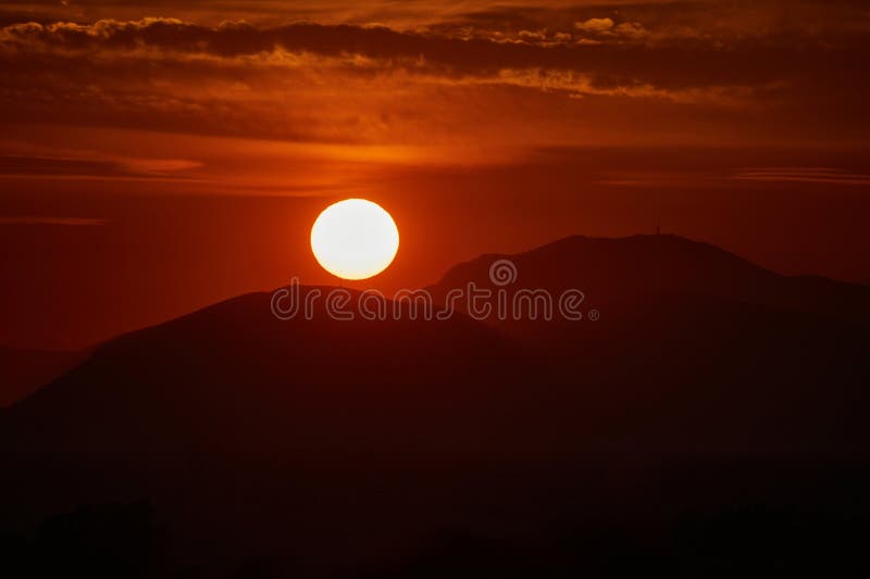 Sunset through Cloudy Red Sky Over Hills Stock Photo - Image of nature ...
