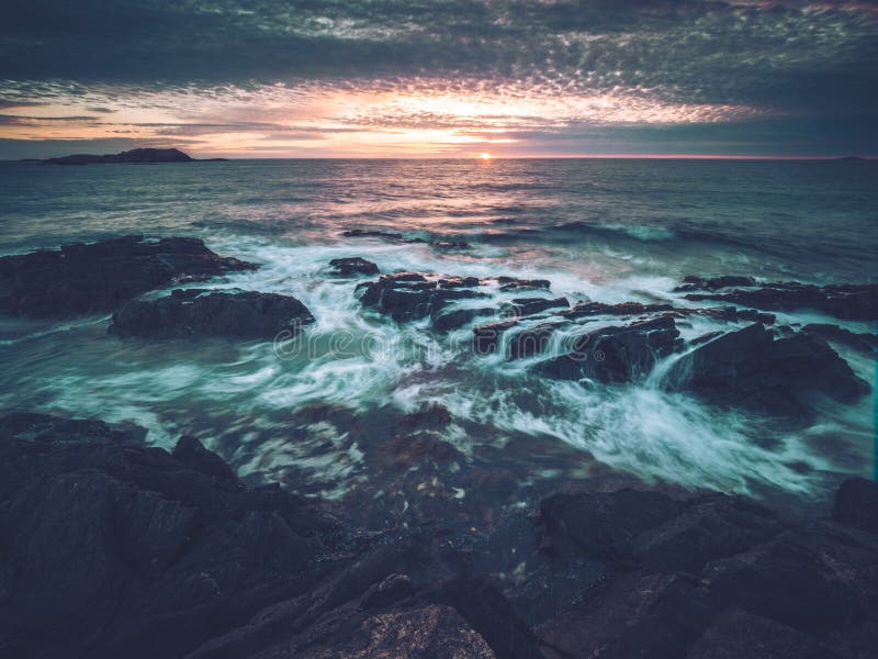 Sunset at Coast with Rocks and Sea in Foreground Stock Photo - Image of ...
