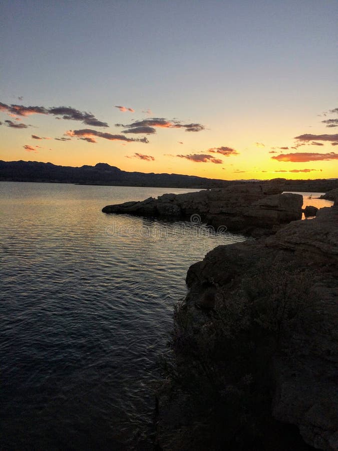 Sunset colors over a lake stock image. Image of colors - 157606349