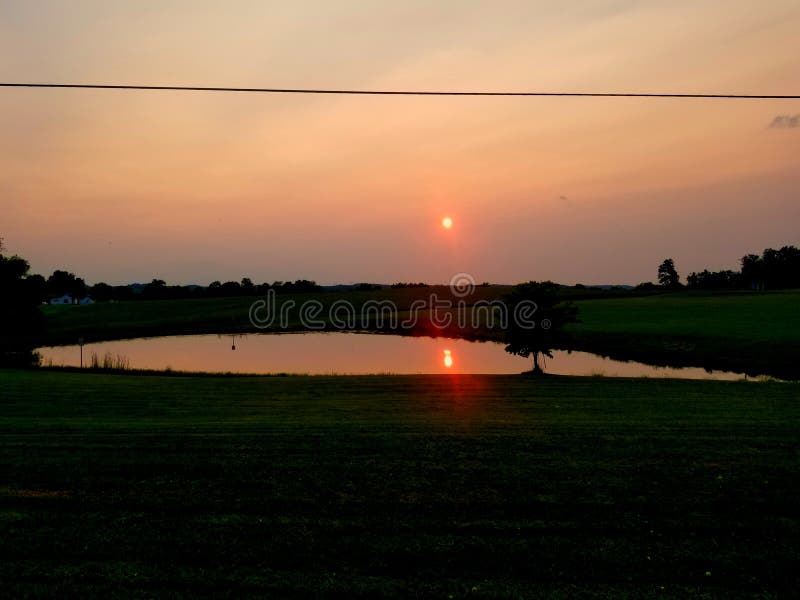 Sunset on country pond stock image. Image of reflections - 149371473
