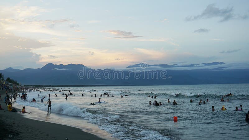 Sunset in a Crowded Beach with Small Waves Editorial Photography ...