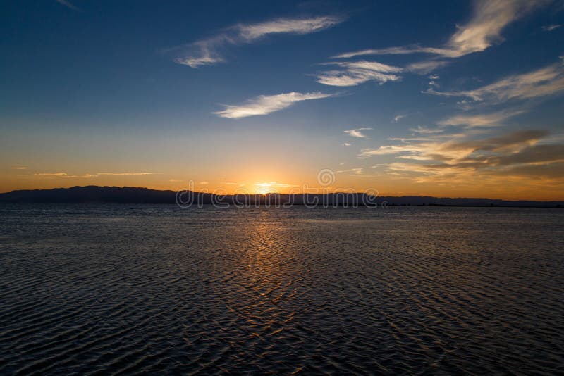 Sunset in the delta stock photo. Image of reflection - 121180032