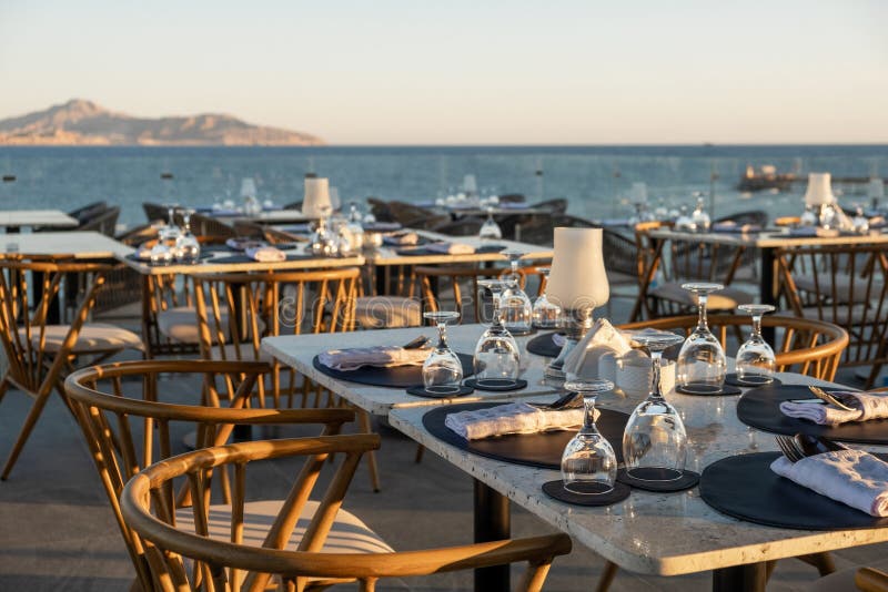 Sunset Dining by the Sea with Elegantly Set Tables and Glassware ...
