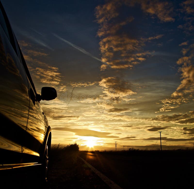 Sunset in the Distant with a Parked Car on the Left Stock Image - Image ...
