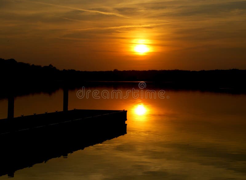Sunset with Dock stock photo. Image of orange, waves, shadow - 7100946