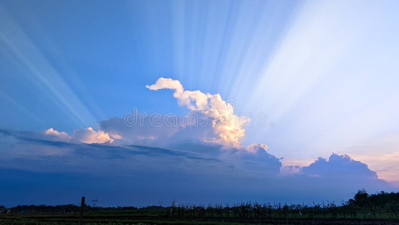 Sunset with Dramatic Blue Sky with Orange Sun Rays Breaking through the ...