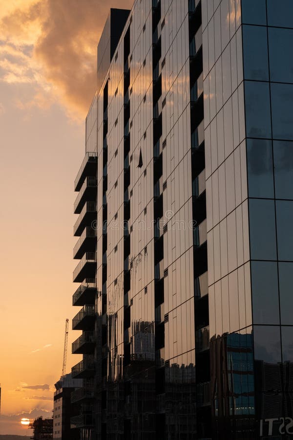 Sunset and Dramatic Clouds Reflected in the Windows of a Skyscraper ...