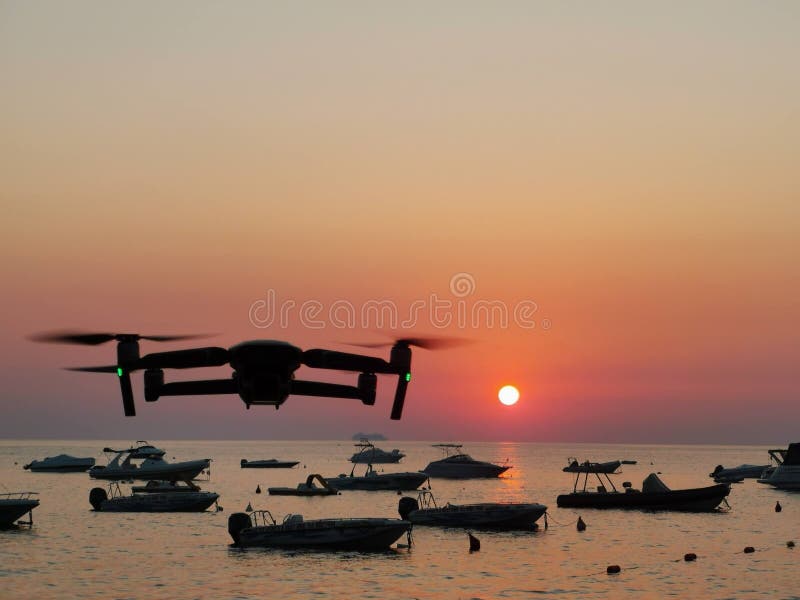 A Sunset with a Drone Flying in the Sky Over Boats Stock Photo - Image ...