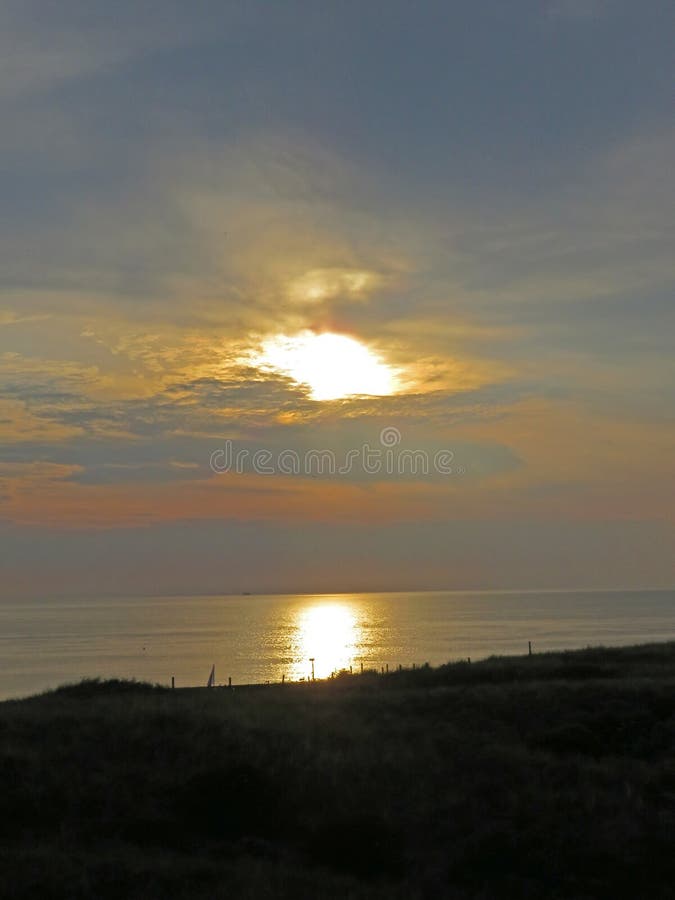 Sunset at the dutch coast stock photo. Image of moment - 151589292